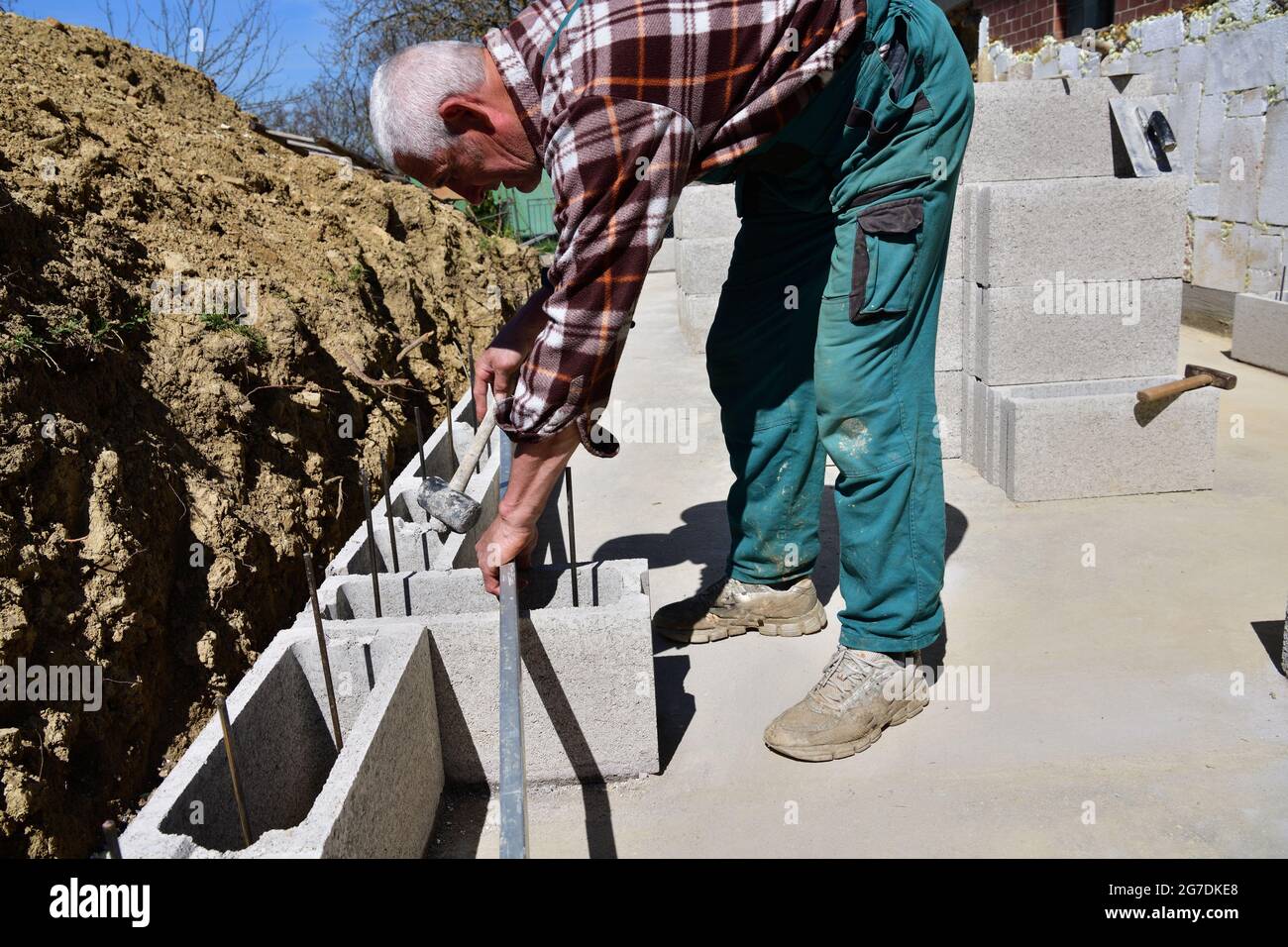 The mason on the construction site measures the perpendicularity of the ...
