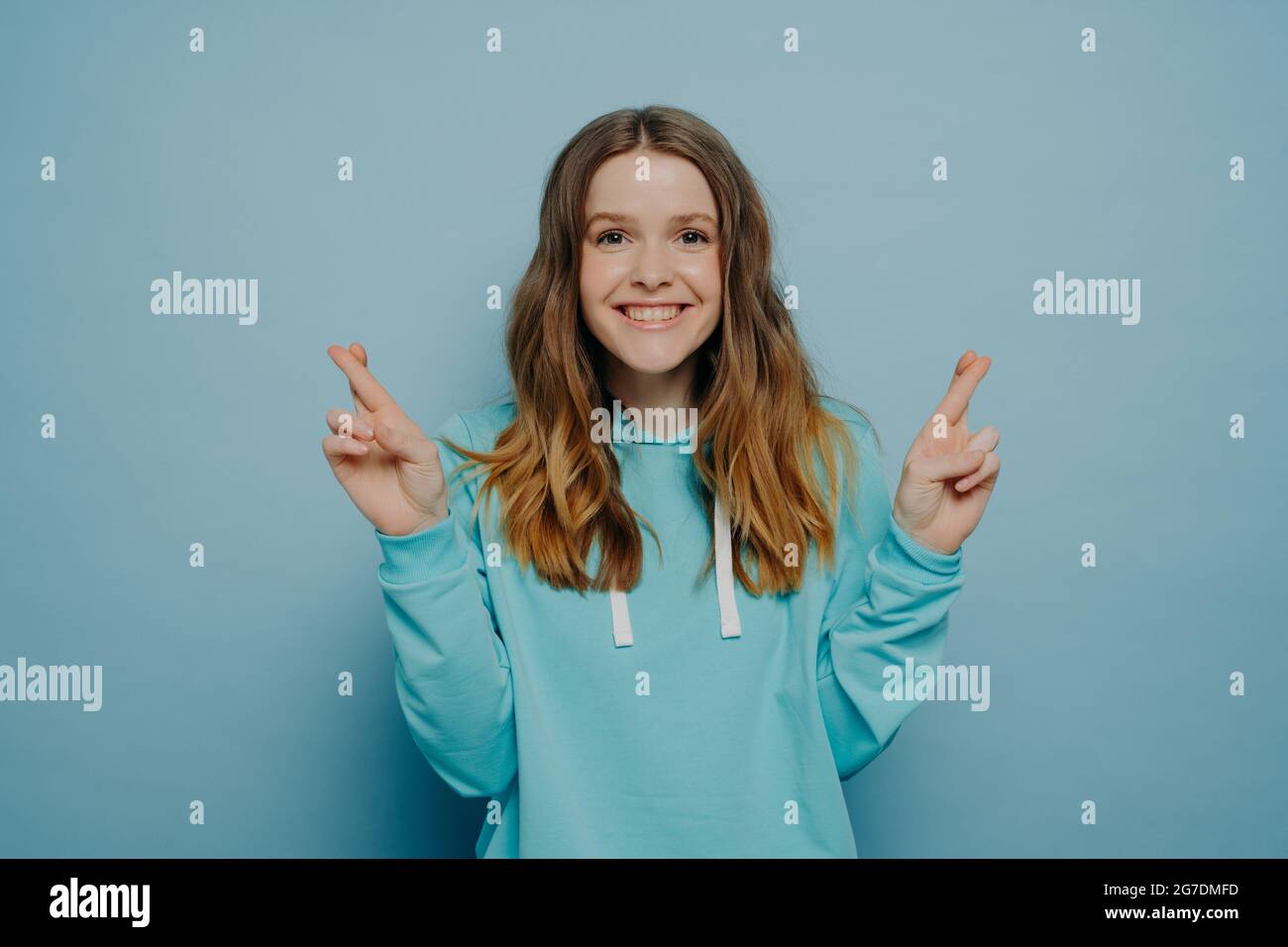 Girl with fingers crossed hi-res stock photography and images - Alamy