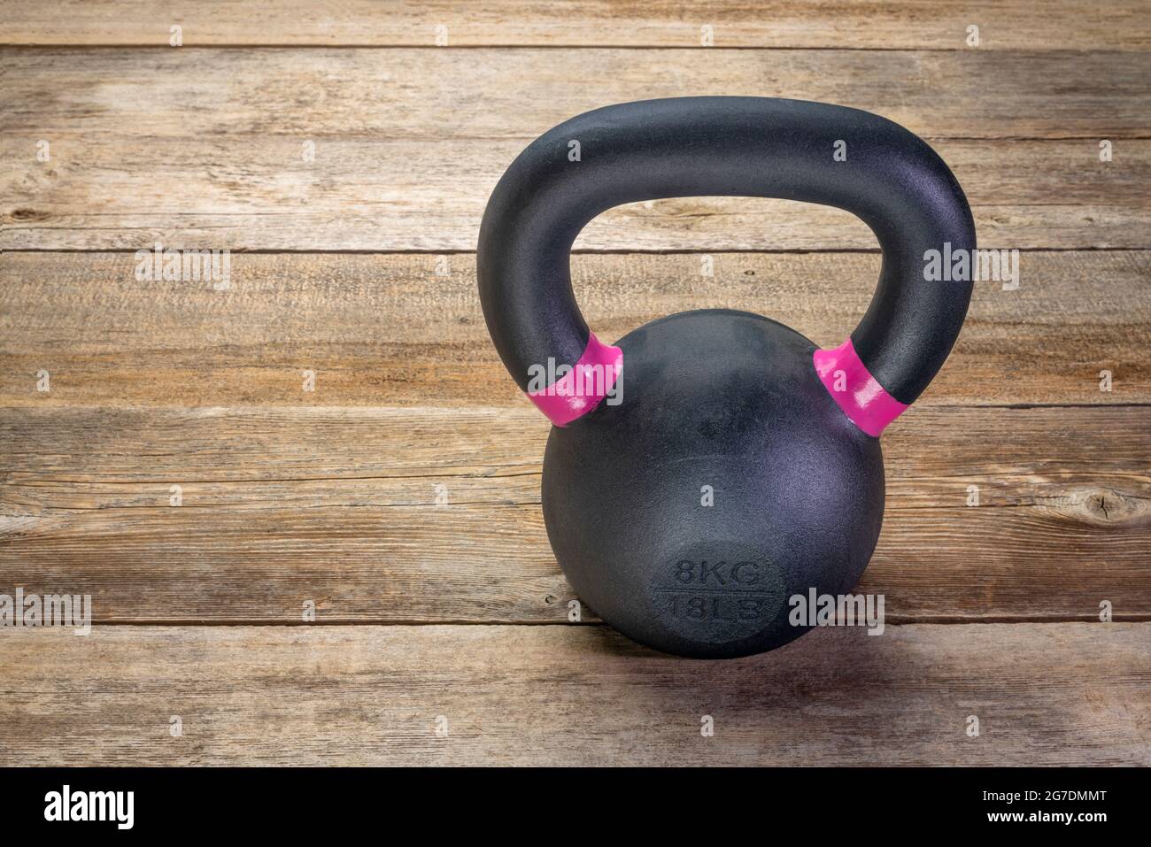 small iron kettlebell on a rustic wood background with a copy space ...