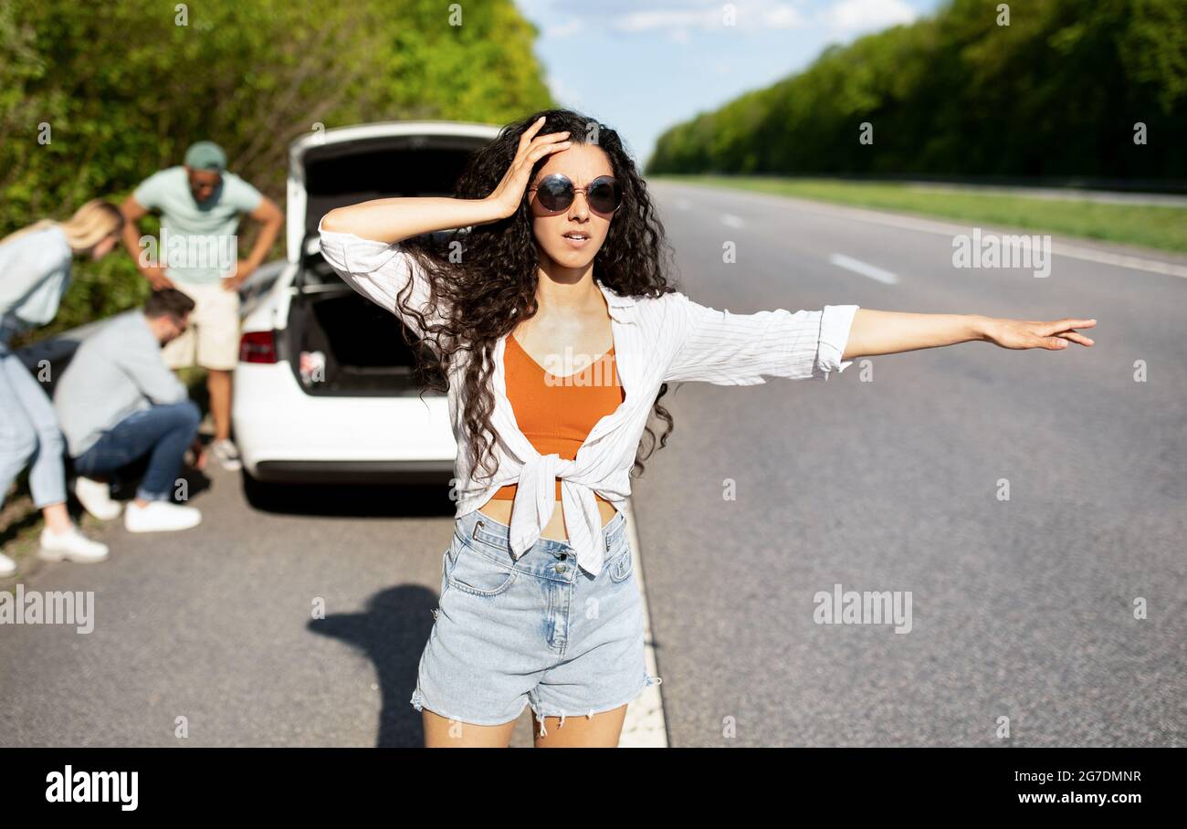 Woman standing by road hi-res stock photography and images - Alamy