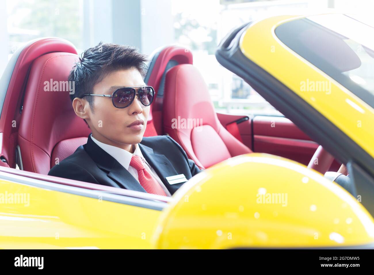 Asian man testing new sports car Stock Photo - Alamy