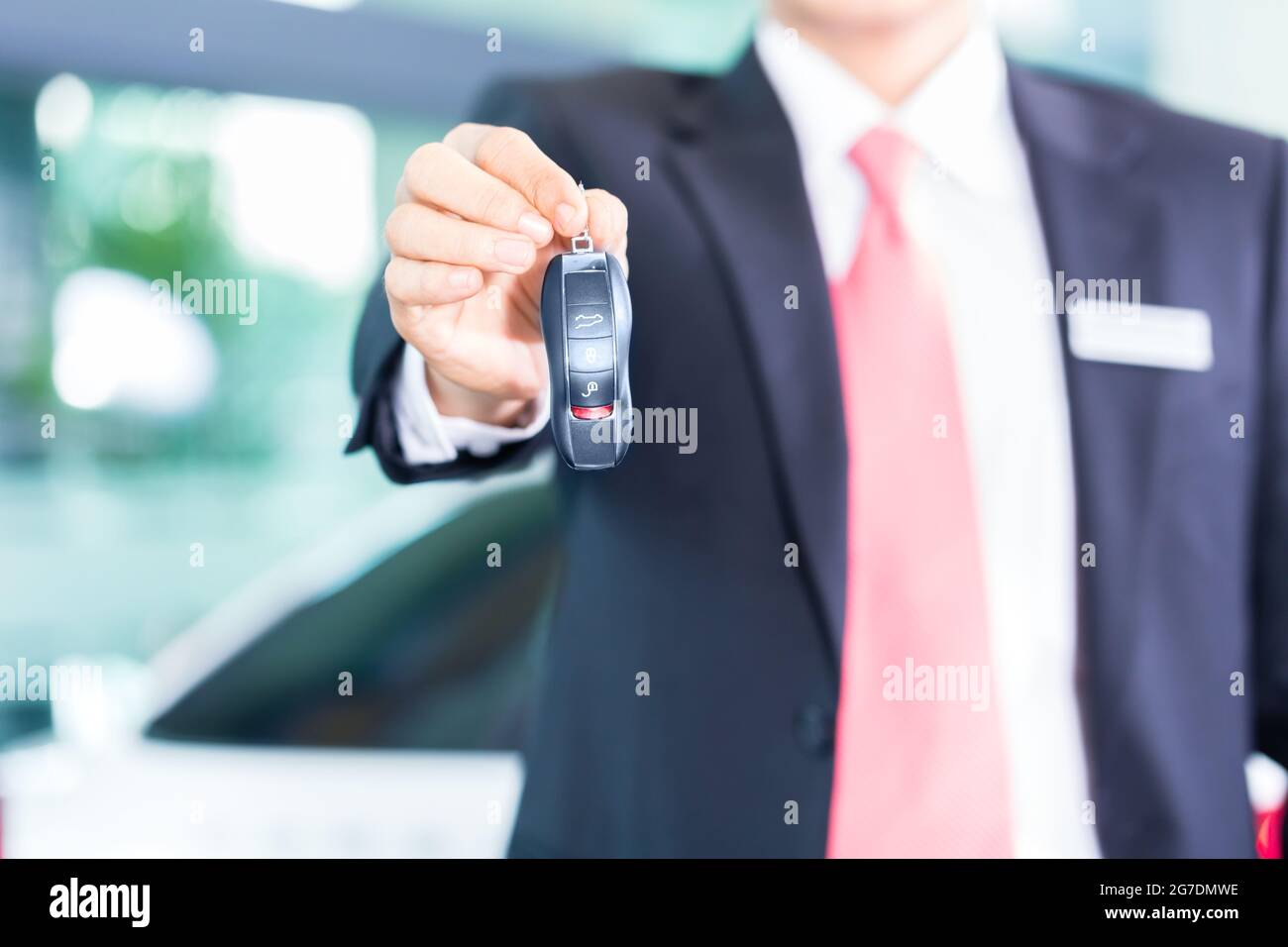 Car dealer handing over auto key Stock Photo - Alamy