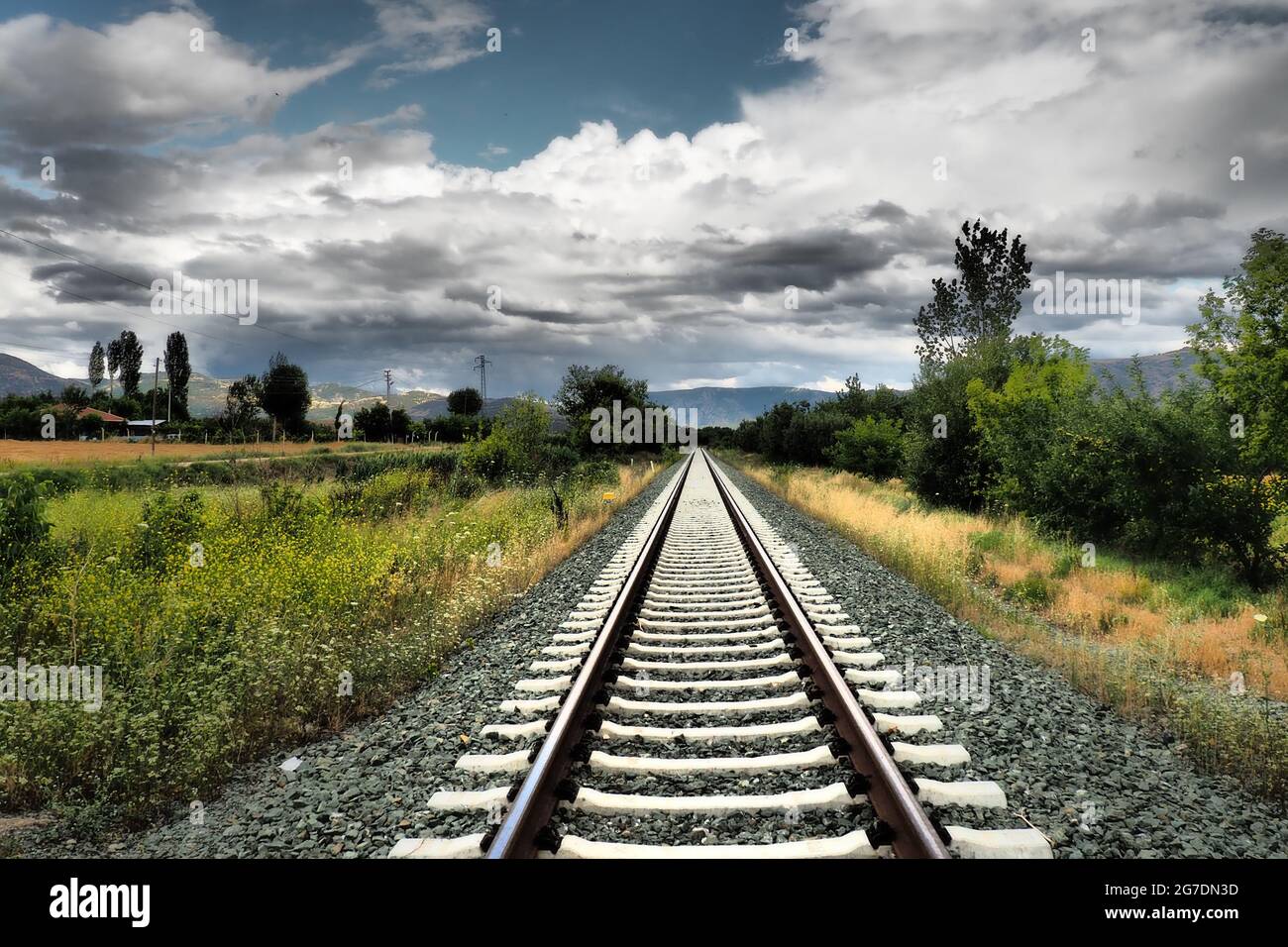 train tracks and rain clouds Stock Photo - Alamy