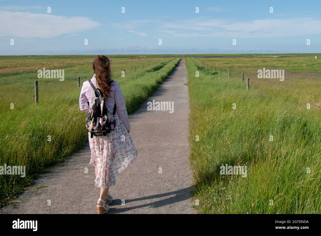 Girl walking through the path in the field during daytime Stock Photo ...