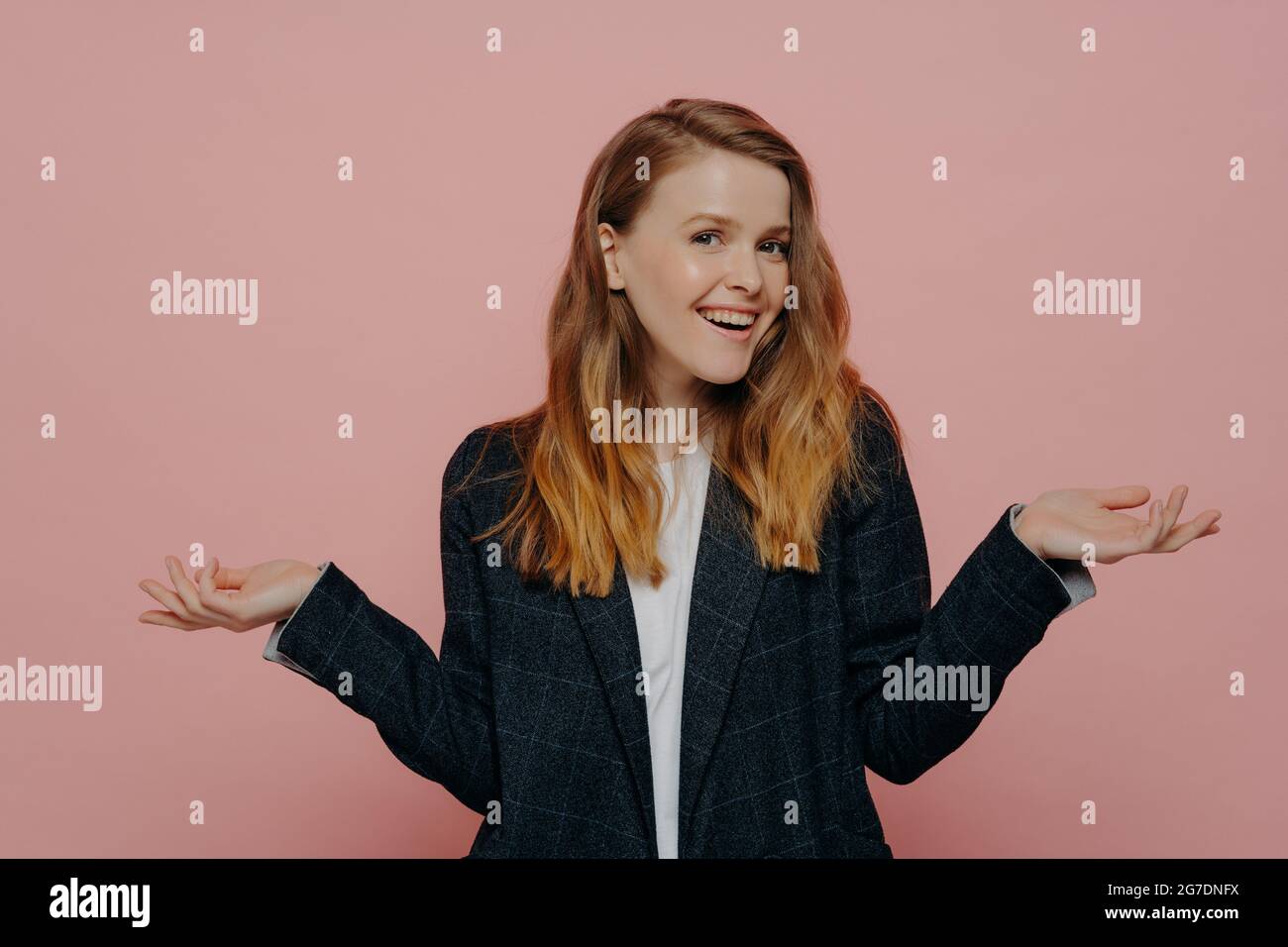 Positive young girl raising hands with open palm gesture Stock Photo ...