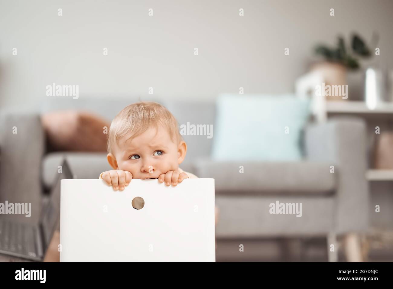 Cute boy sitting in the white plastic box Stock Photo - Alamy