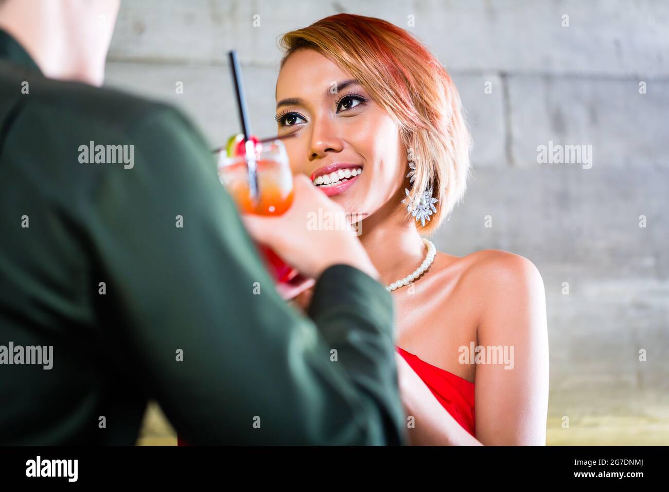 Asian couple drinking cocktails in fancy bar Stock Photo - Alamy