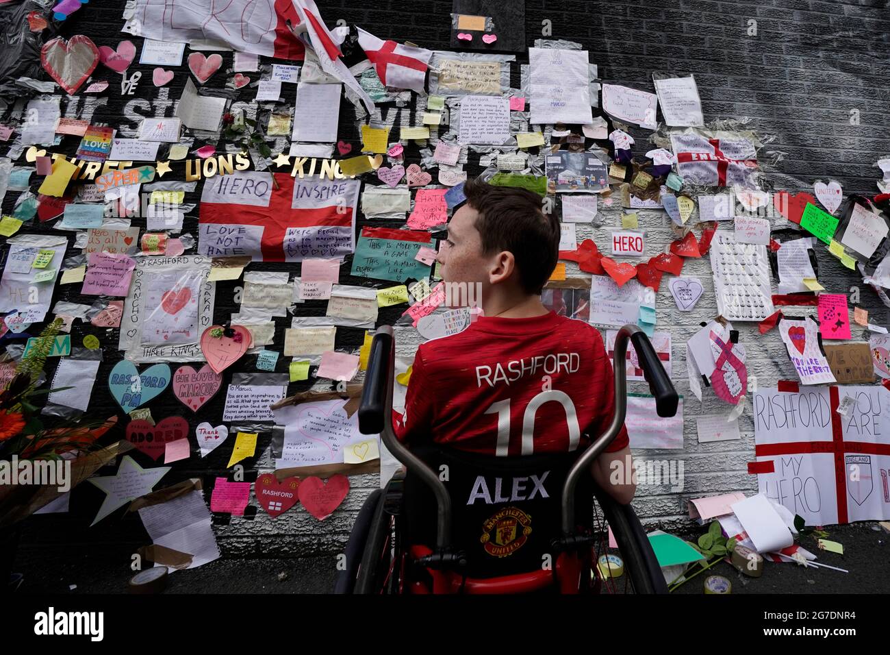 Alex, 14, in front of the mural of Manchester United striker and ...