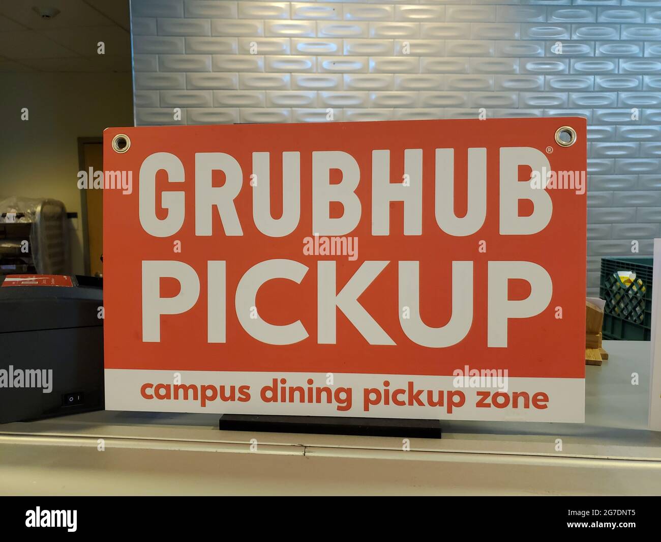 Front view of a sign reading 'Grubhub Pickup' at a campus dining pickup ...