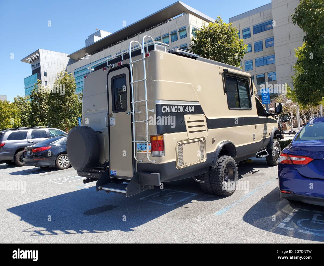 Back view of the Chinook 4x4 RV from a modified van at a parking lot in ...