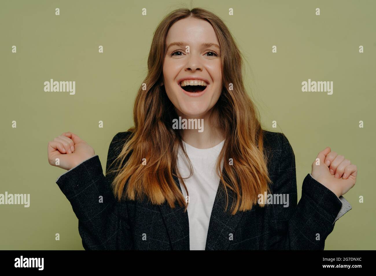 Excited young woman in formal wear expressing positivity Stock Photo ...