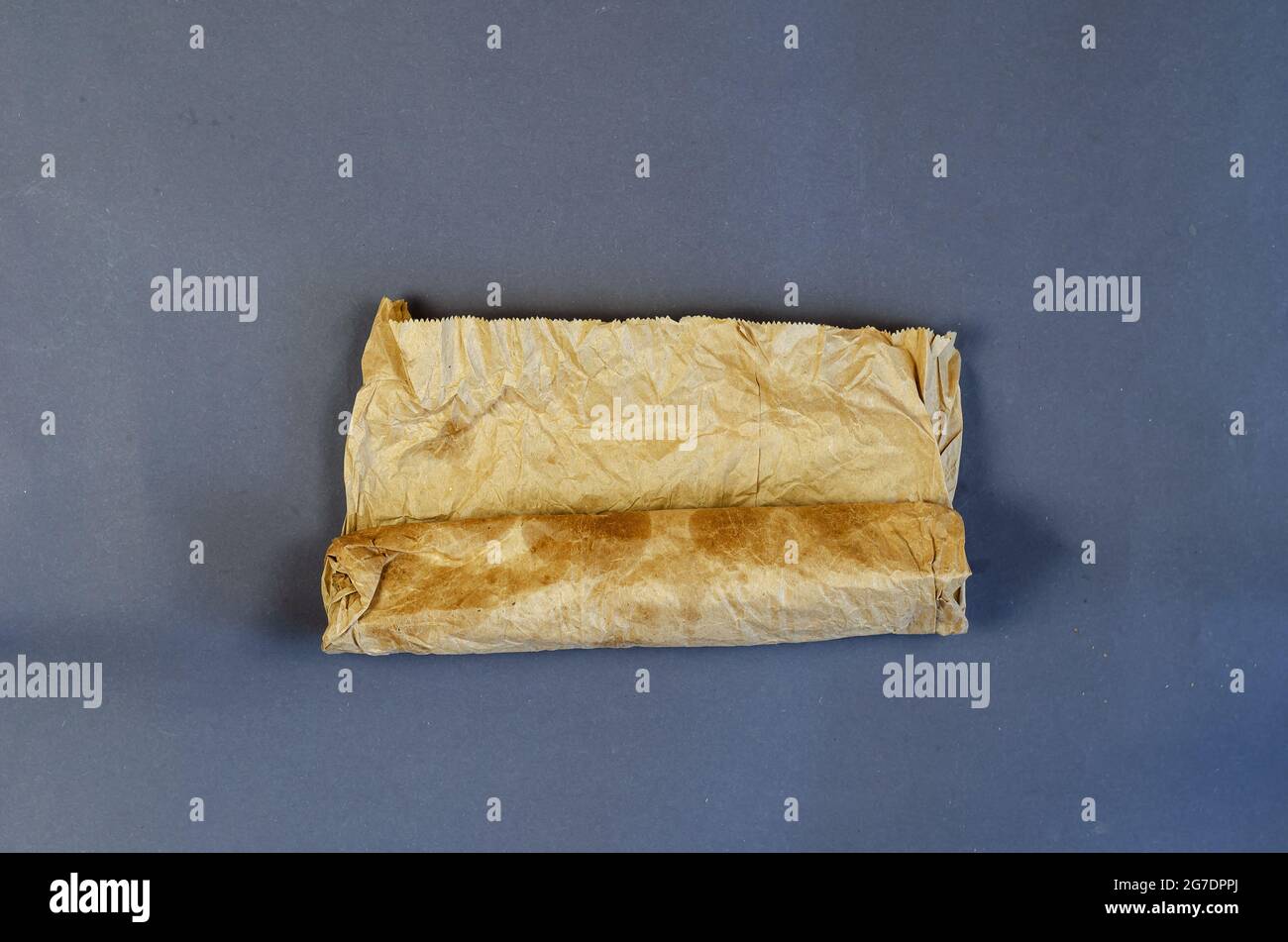 Twisted Dirty brown paper bag on gray background. Paper bag used for ...