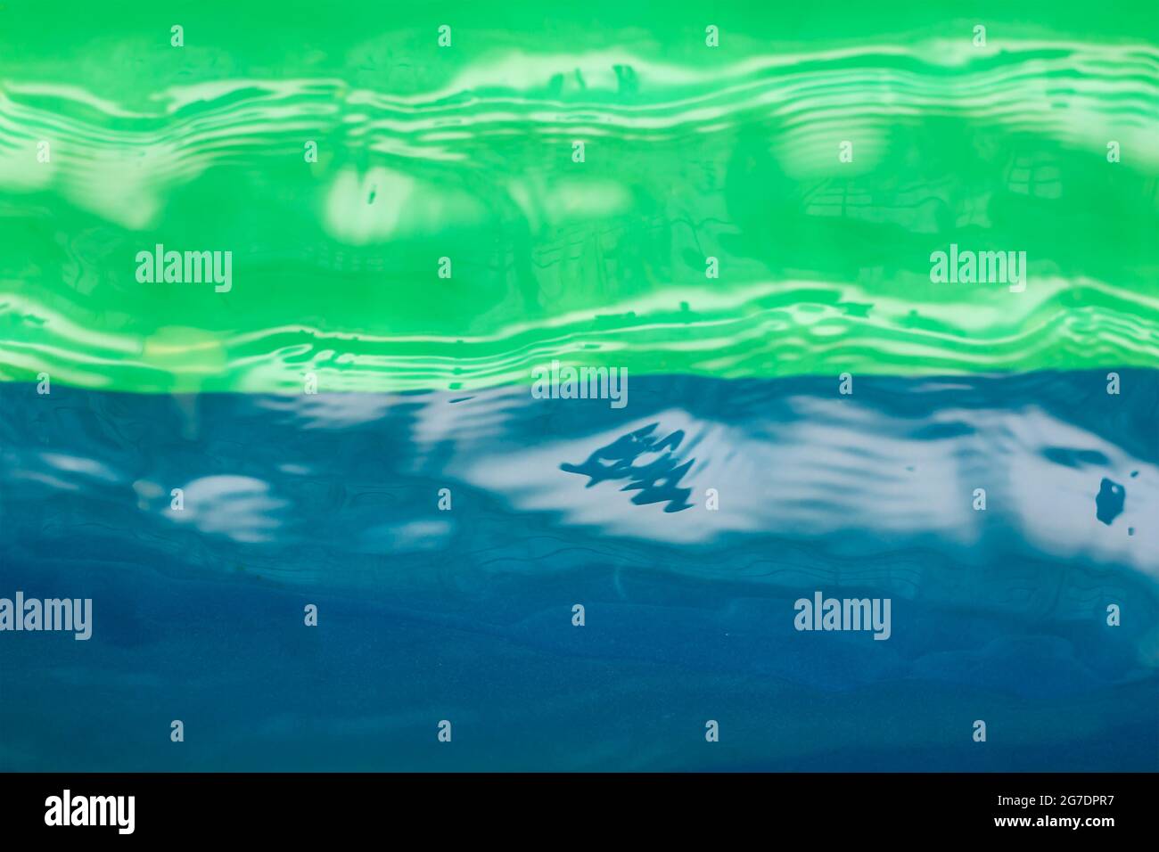 Defocused shot of transparent water against blue and green. Water ...