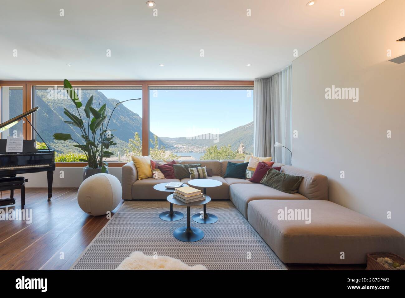 Front view of a living room with large, light-colored sofa and lots of ...