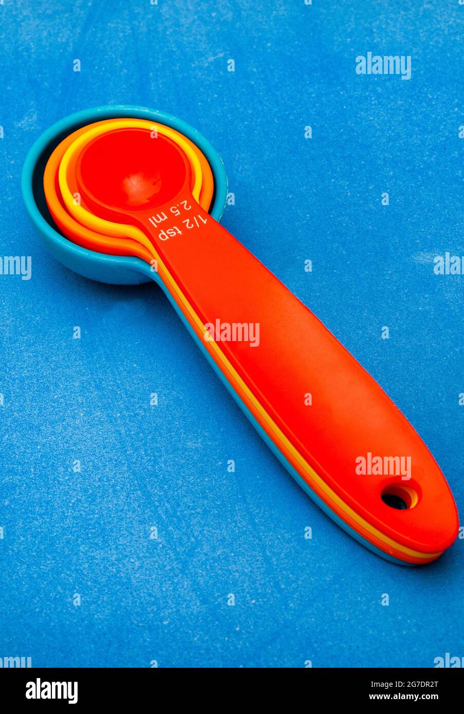 colorful measuring spoon set on blue background Stock Photo - Alamy