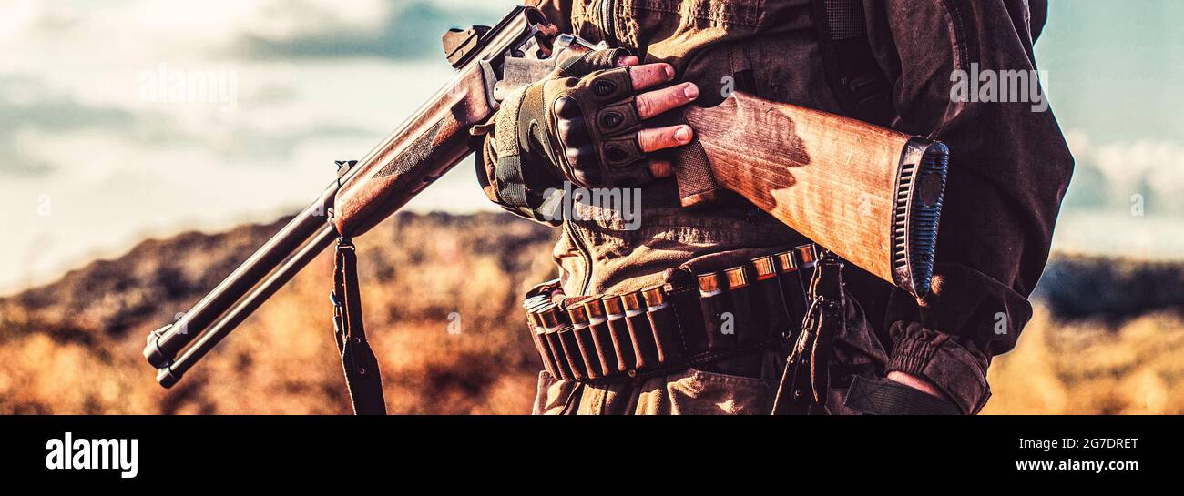 Hunting period, autumn season. Male with a gun. Hunter with a backpack ...