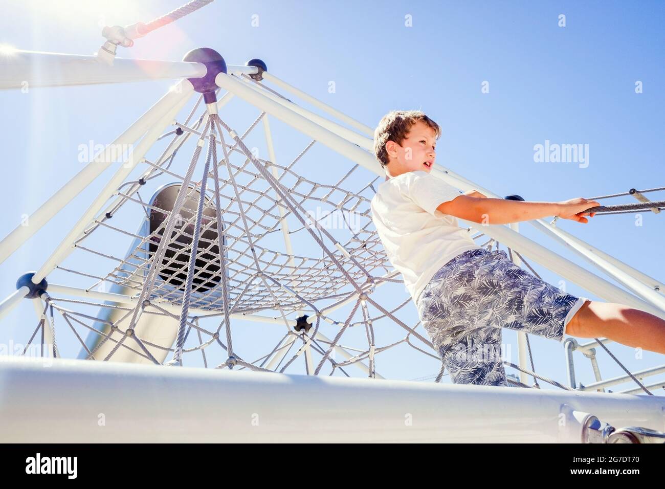 Young boy having fun at an outdoor physical attraction in summer Stock ...