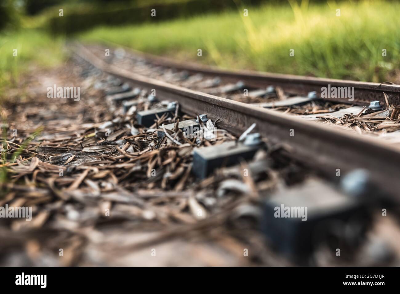 Detail of the old sleepers that hold the rails of a small train track ...