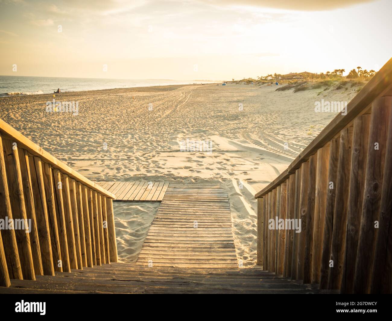 Wooden staircase leading to the sandy beach in Isla Antilla, Huelva ...
