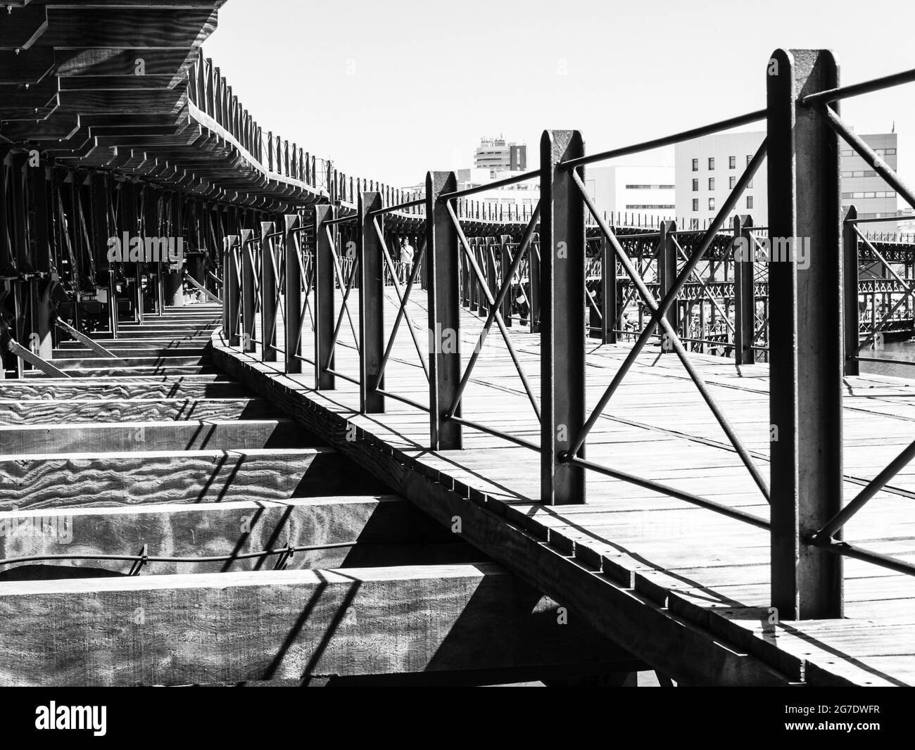 Grayscale shot of the Rio Tinto pier fence structure in Huelva, Spain ...