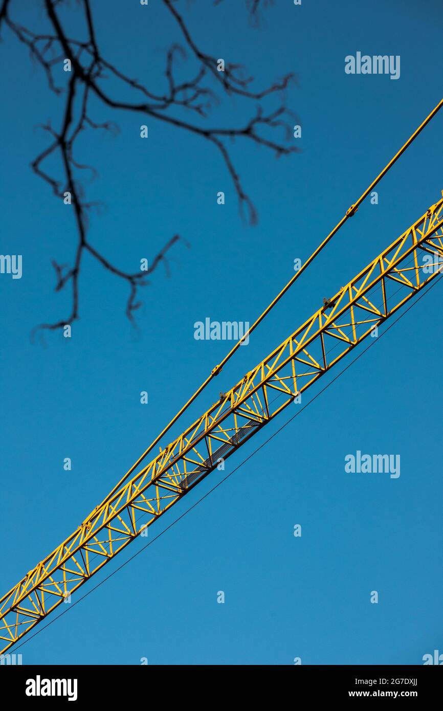 yellow crane on a blue background Stock Photo - Alamy
