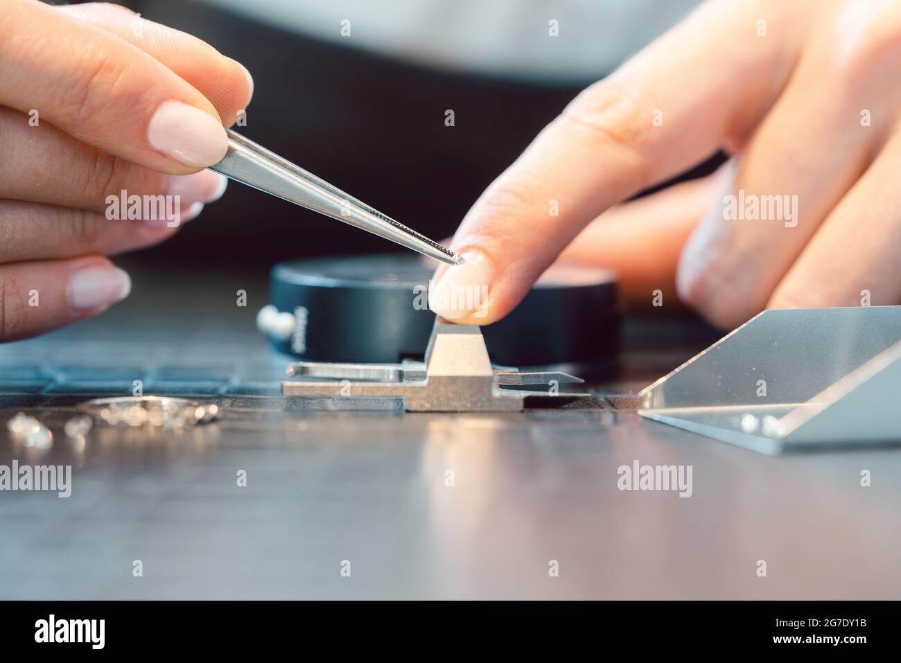Close-up of jeweler sorting pure diamonds on her workbench Stock Photo ...