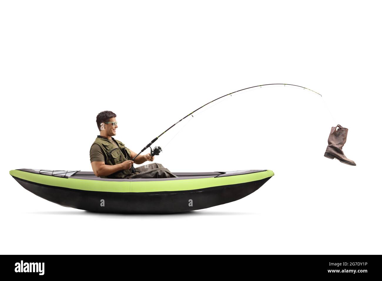 Fisherman in a kayak and a fishing rod with an old shoe on the hook ...