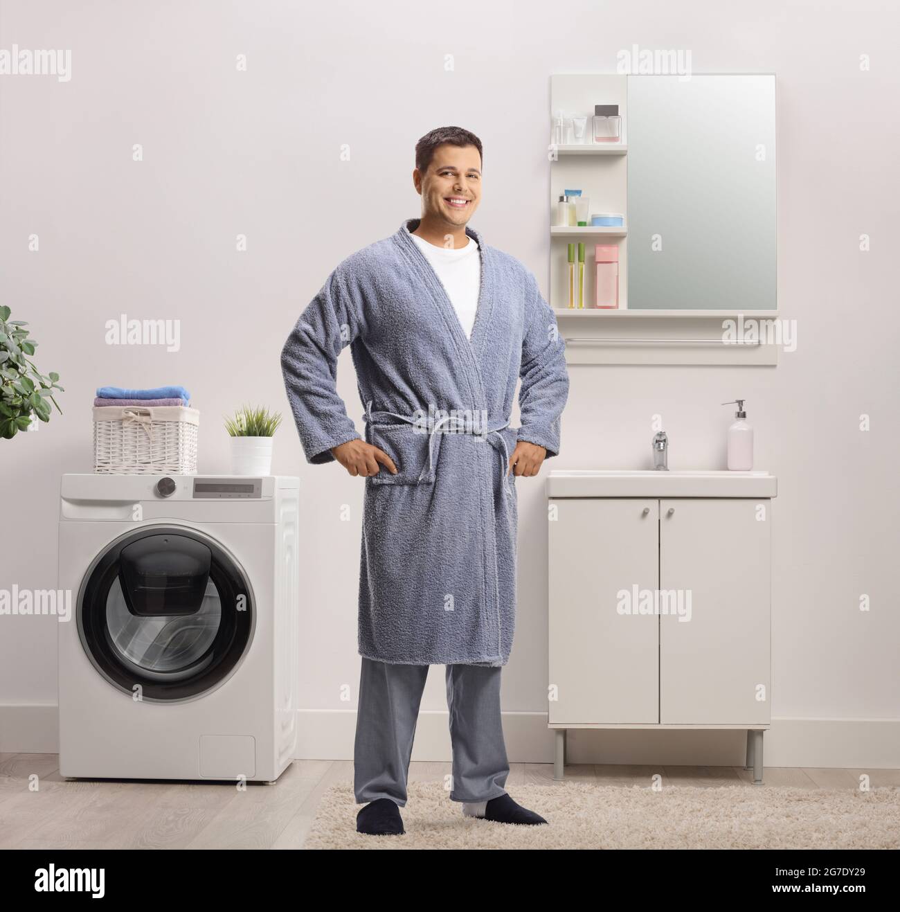 Full length portrait of a young man wearing a robe in a bathroom Stock ...