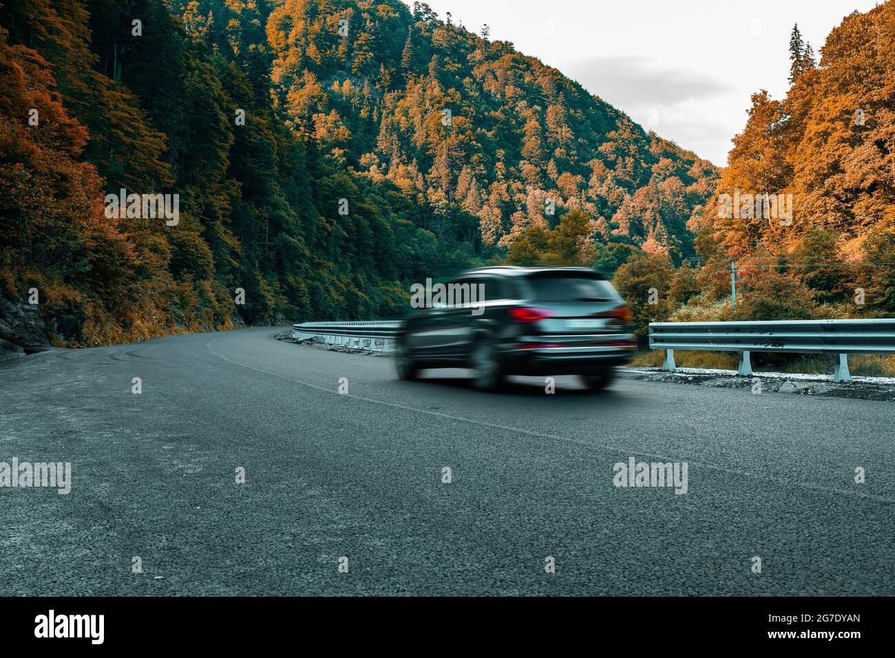 Adventure travel concept background. Car moving fast on empty ...