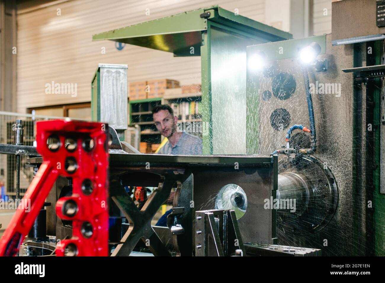 Worker in factory operating industrial milling machine Stock Photo - Alamy