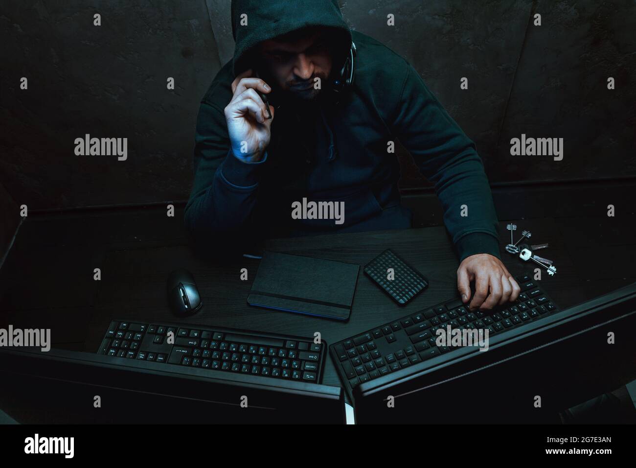 Hacker programmer using computer in dark room Stock Photo - Alamy