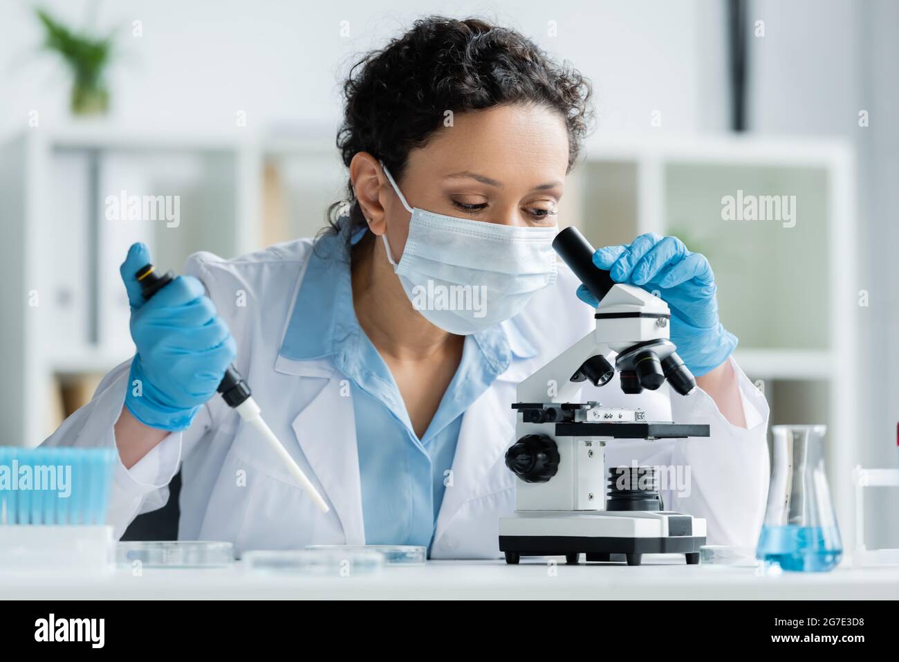 Black woman looking through microscope hi-res stock photography and ...