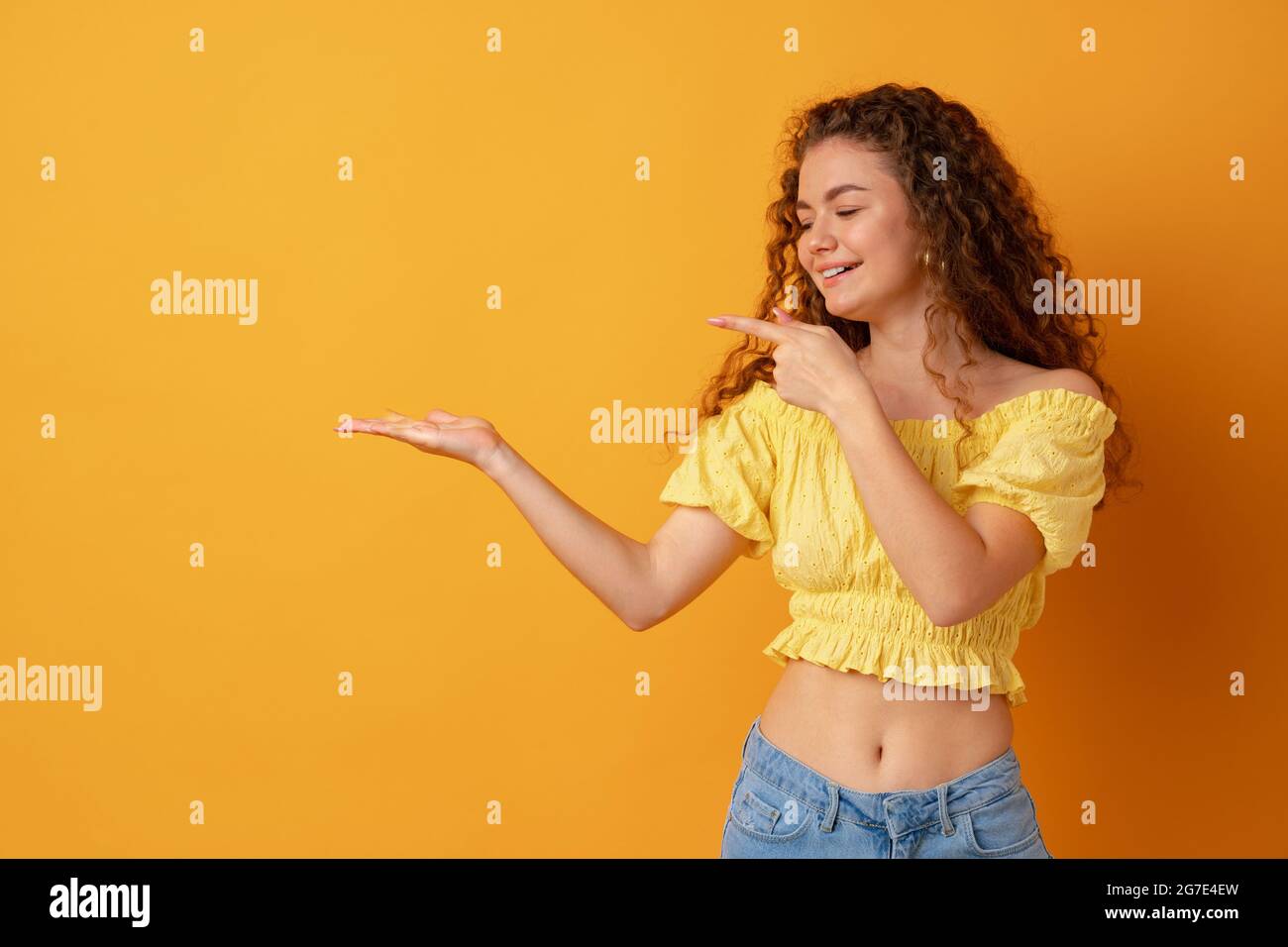 Young cheerful girl smiling point finger to copy space Stock Photo - Alamy