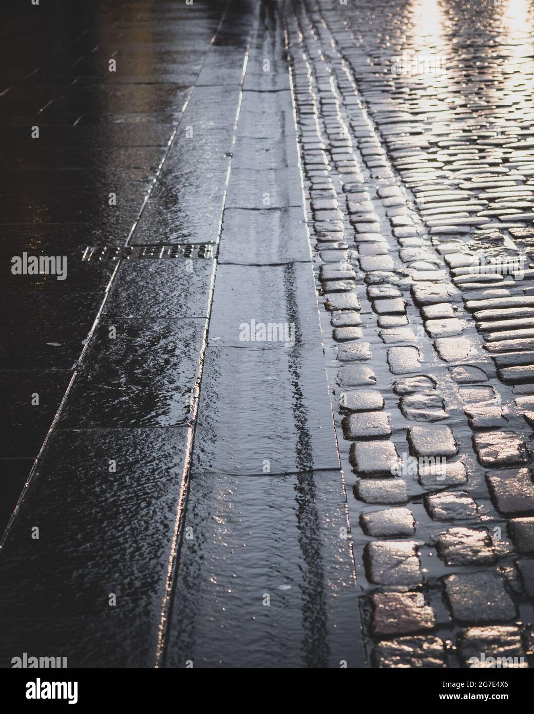 Vertical shot of the wet cobblestone sidewalk after the rain Stock ...