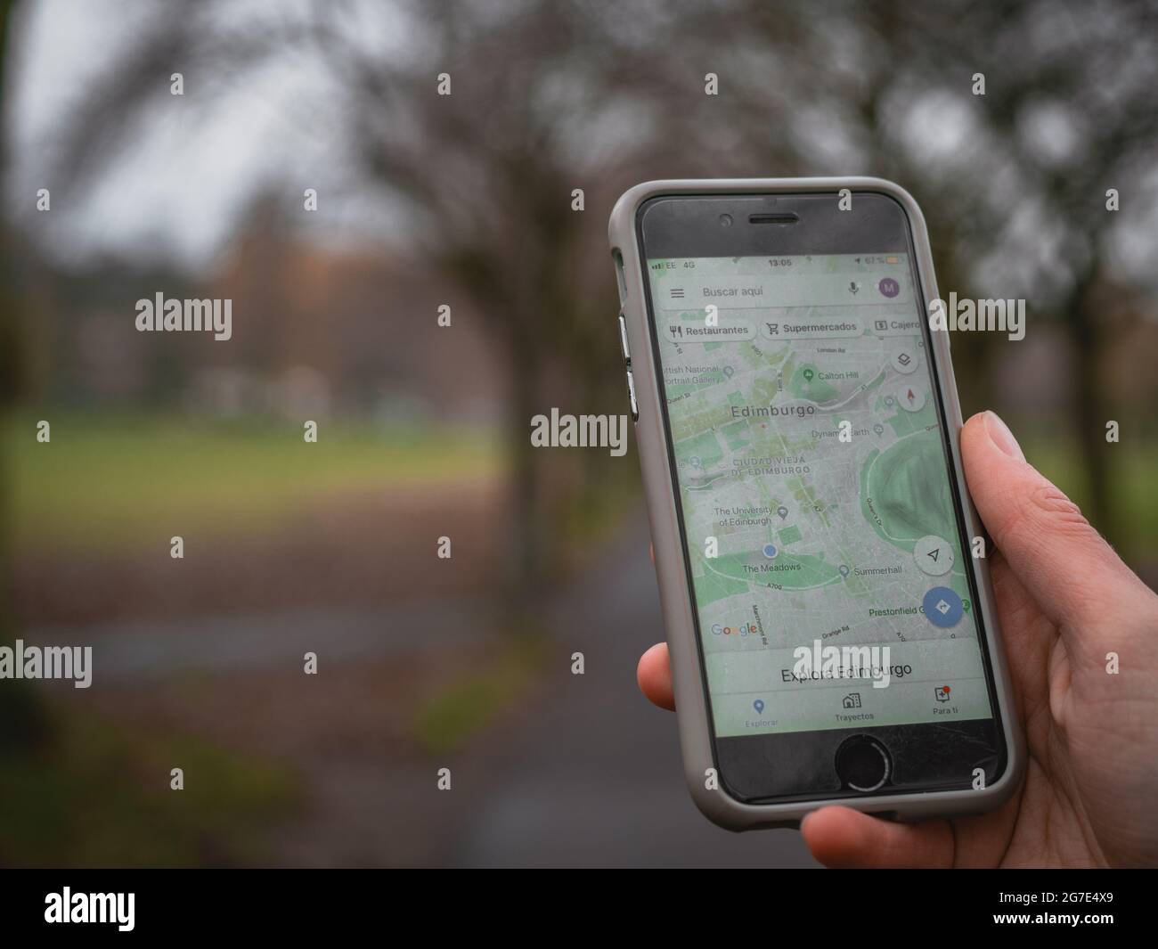 Person searching for a location on his phone Stock Photo - Alamy