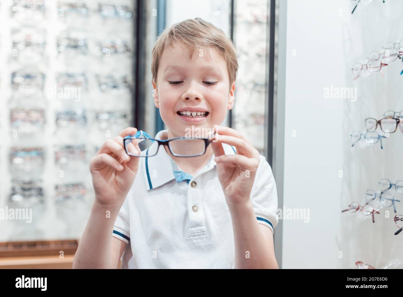 Young boy being very happy with his new and fitting eyeglasses in the ...