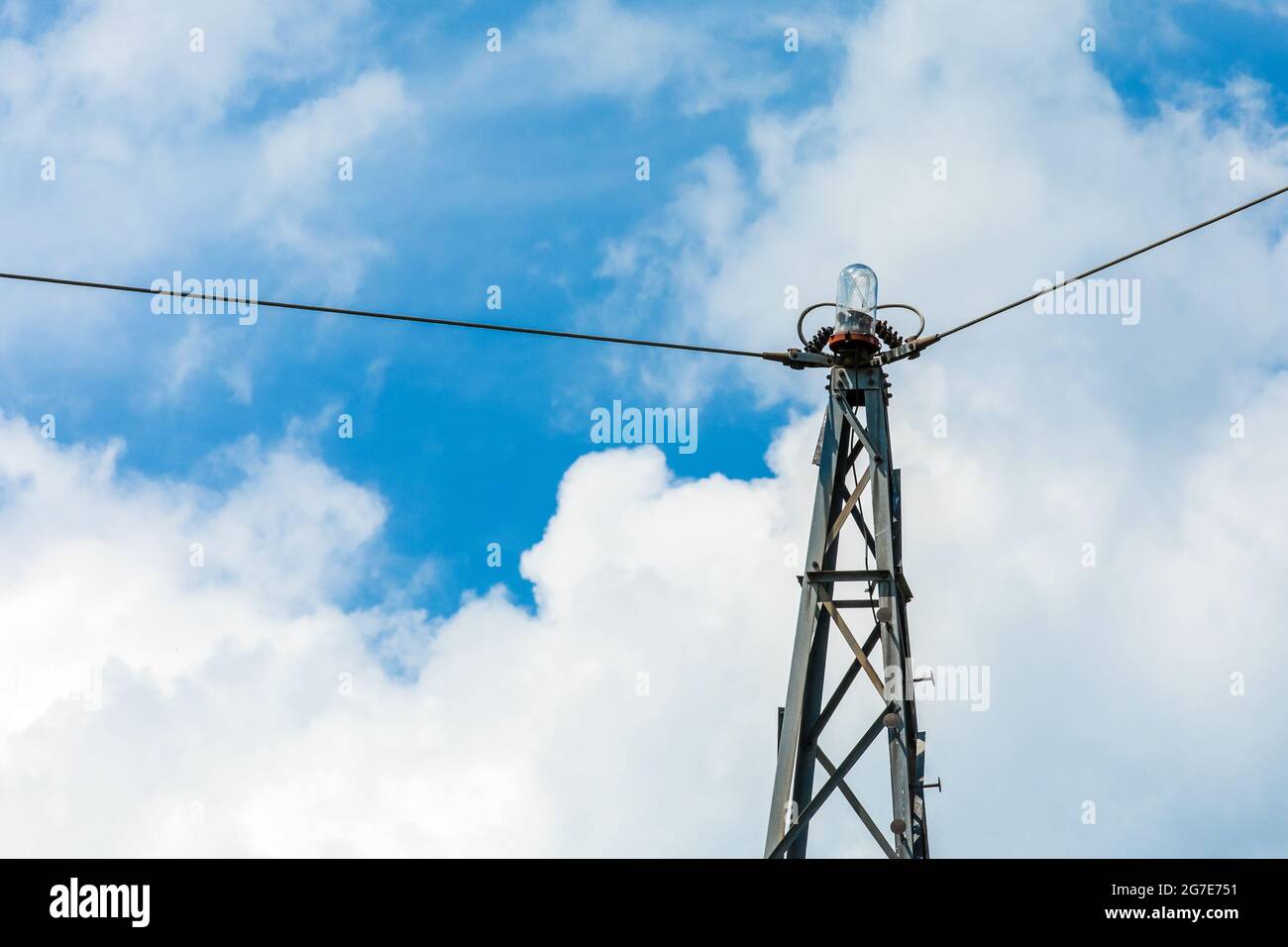 Warning light on a power pole. High voltage electric pylon against ...
