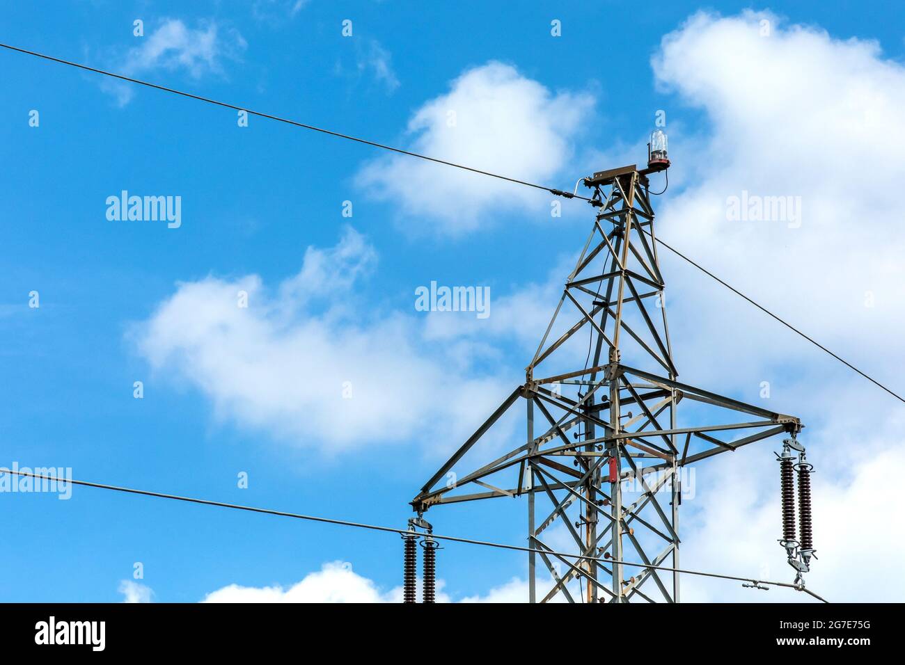 Warning light on a power pole. High voltage electric pylon against ...