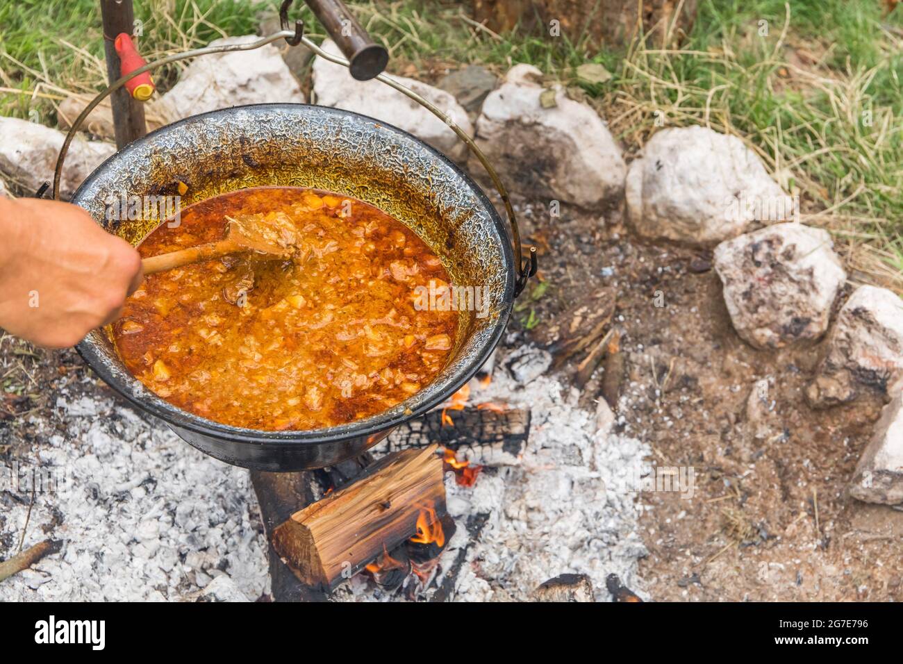 Metal cauldron boiling on a bonfire. Cooking on open fire, camping meal ...