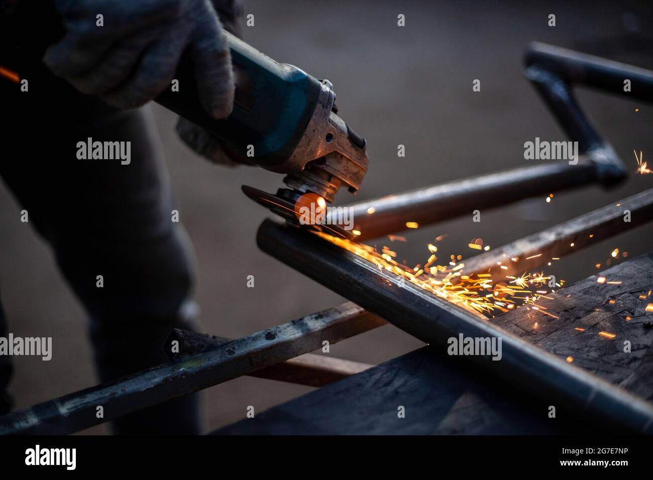 Metal processing in the workshop. Grinding metal. The worker makes the ...
