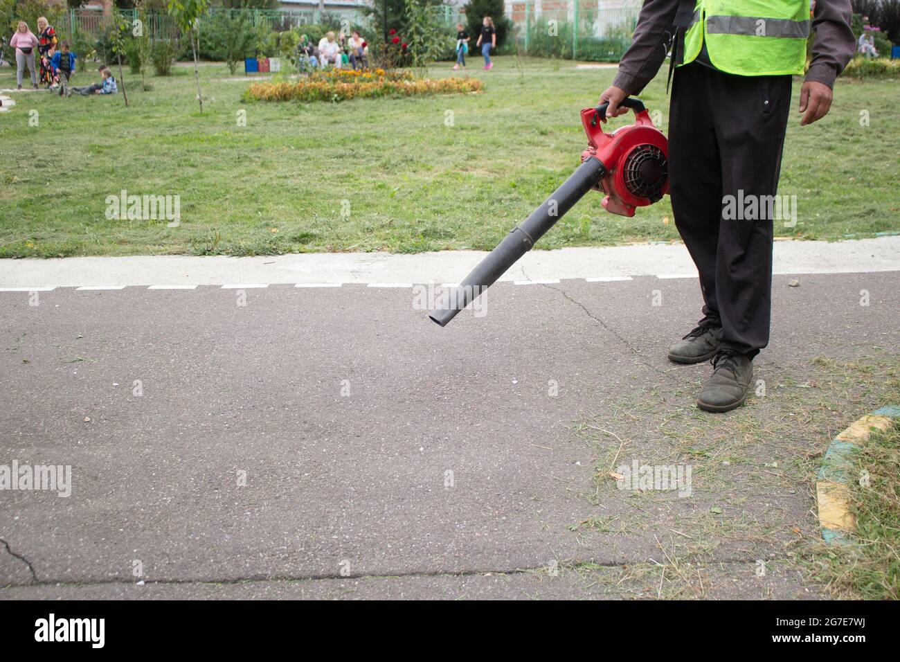 Gardener with a tool. Air turbine in the hand of a worker. Air flow ...