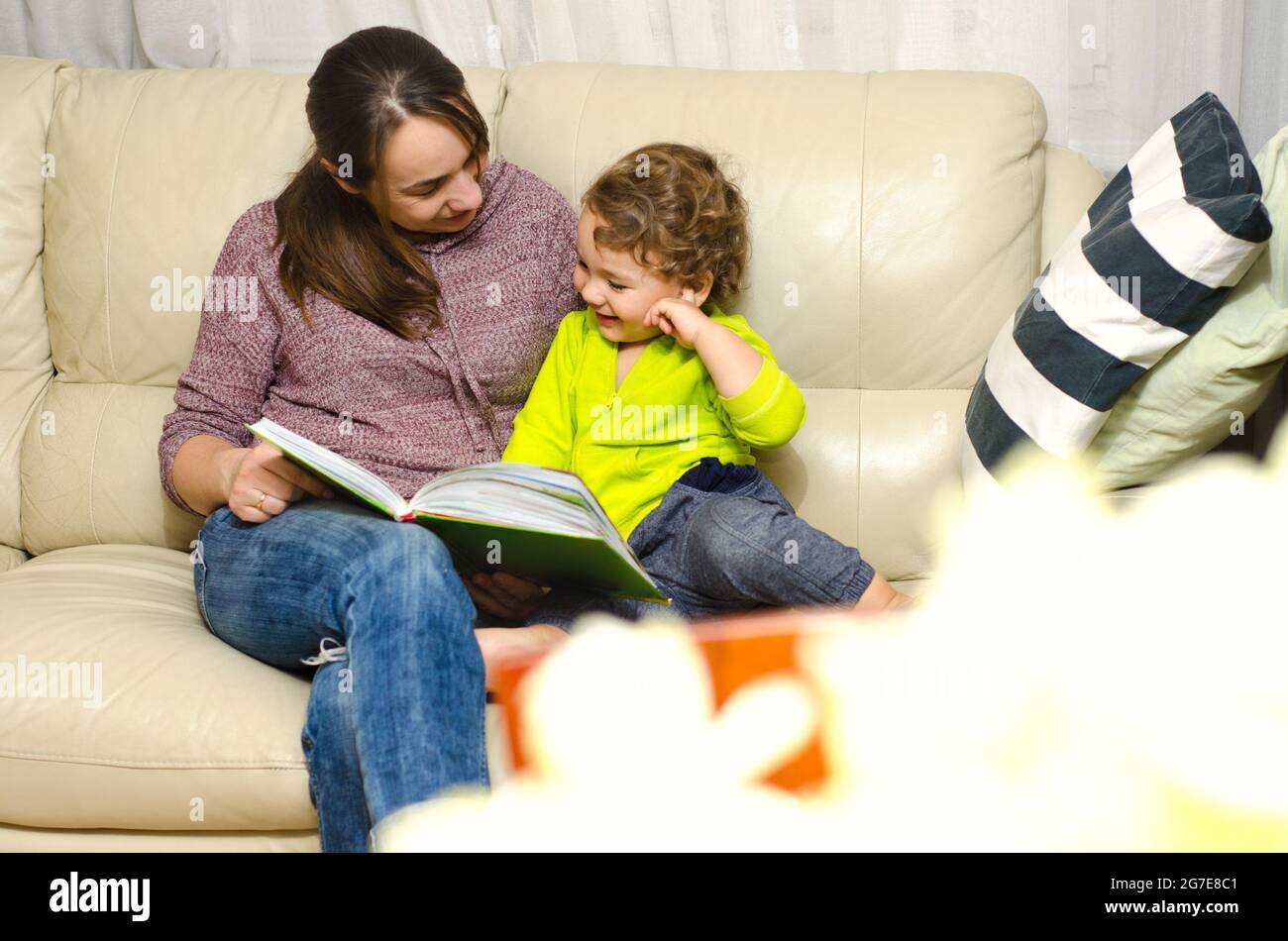 mother and child reading book at home Stock Photo - Alamy