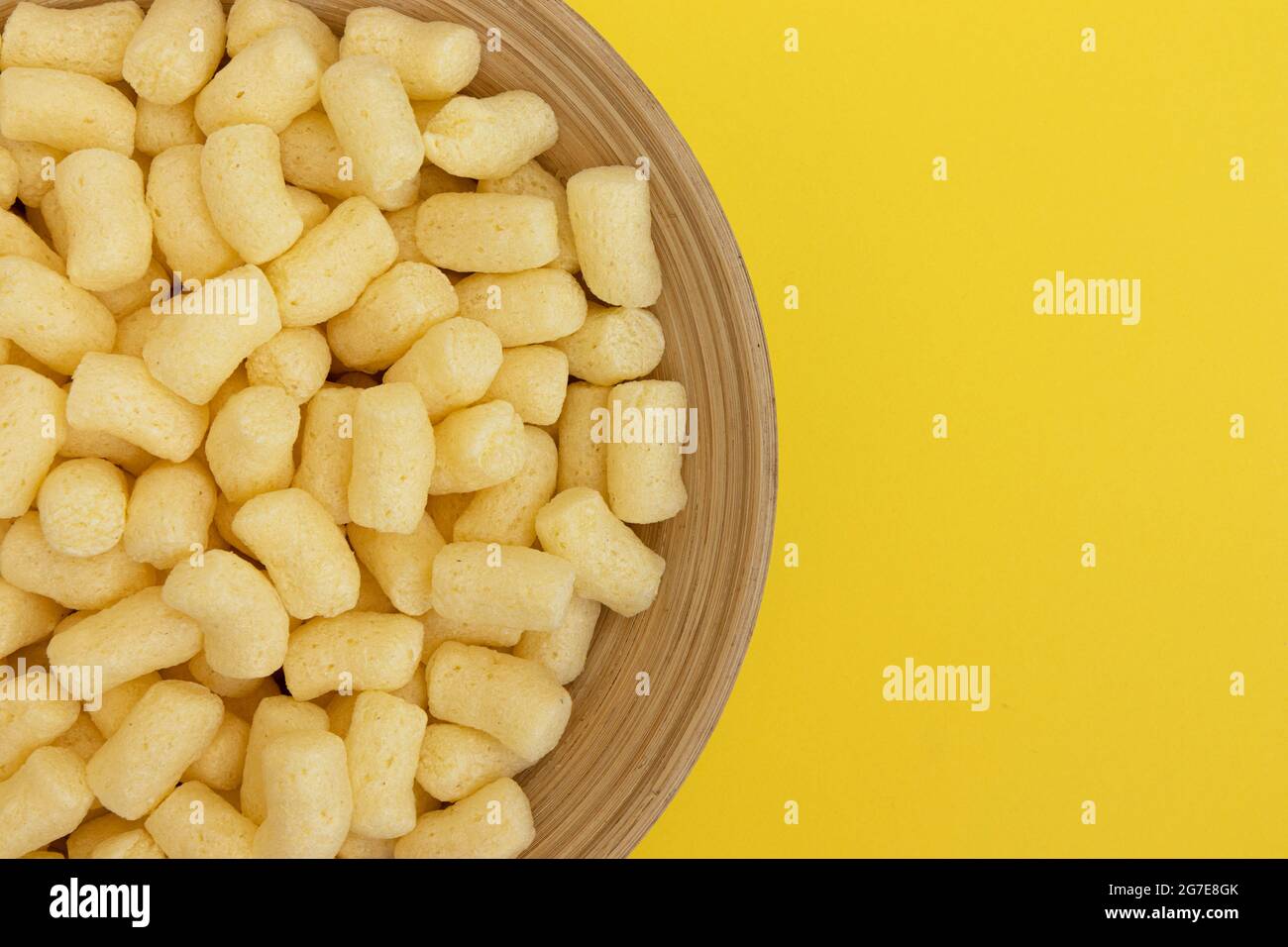 sweet corn sticks in bowl with ampty space for text isolated on yellow ...