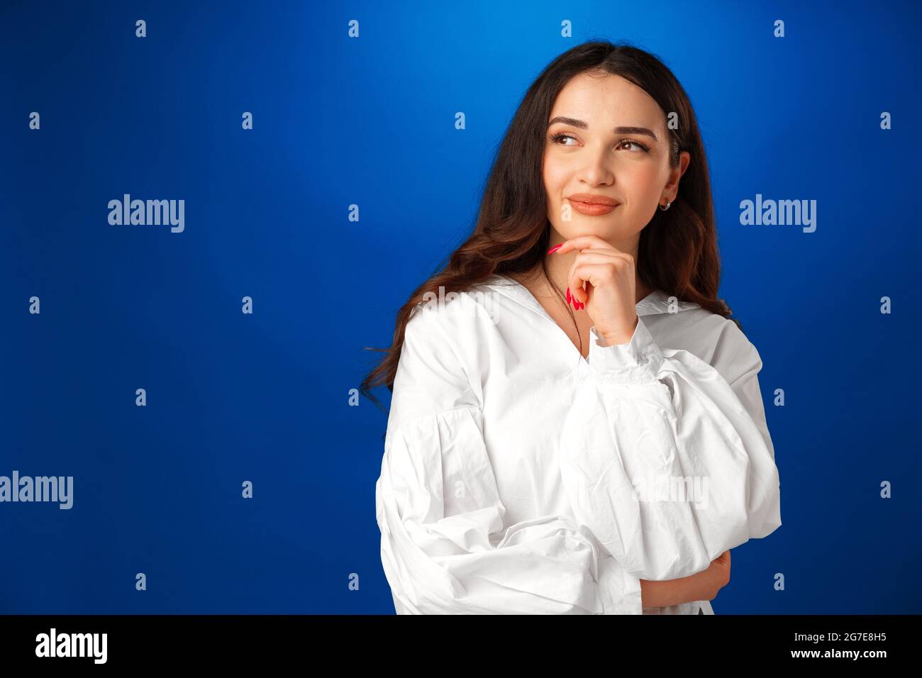 Young beautiful pensive woman thinking about some idea Stock Photo - Alamy