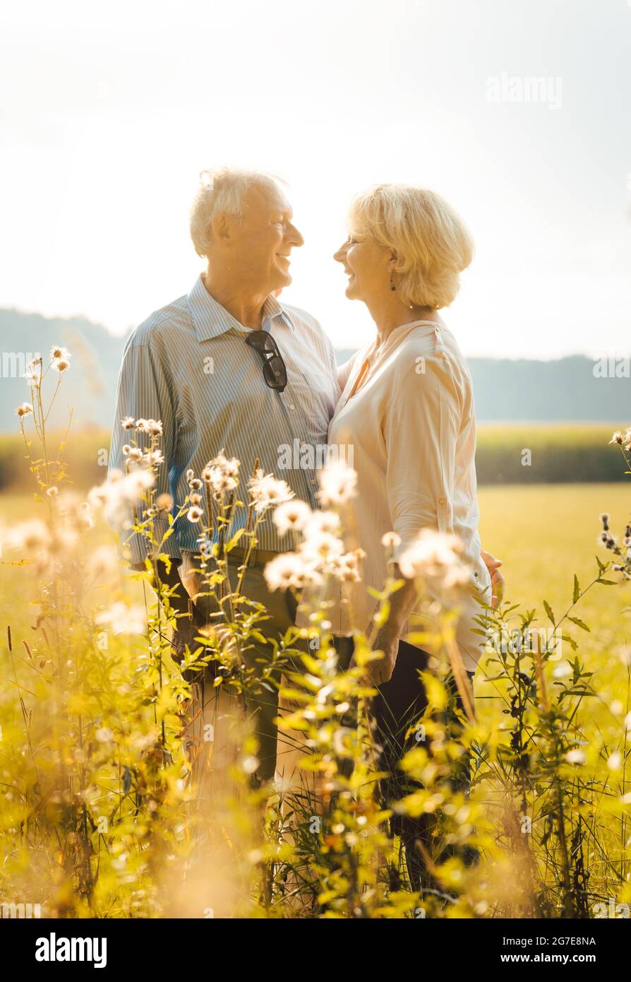 Senior woman and man hugging still being in love in a romantic setting ...