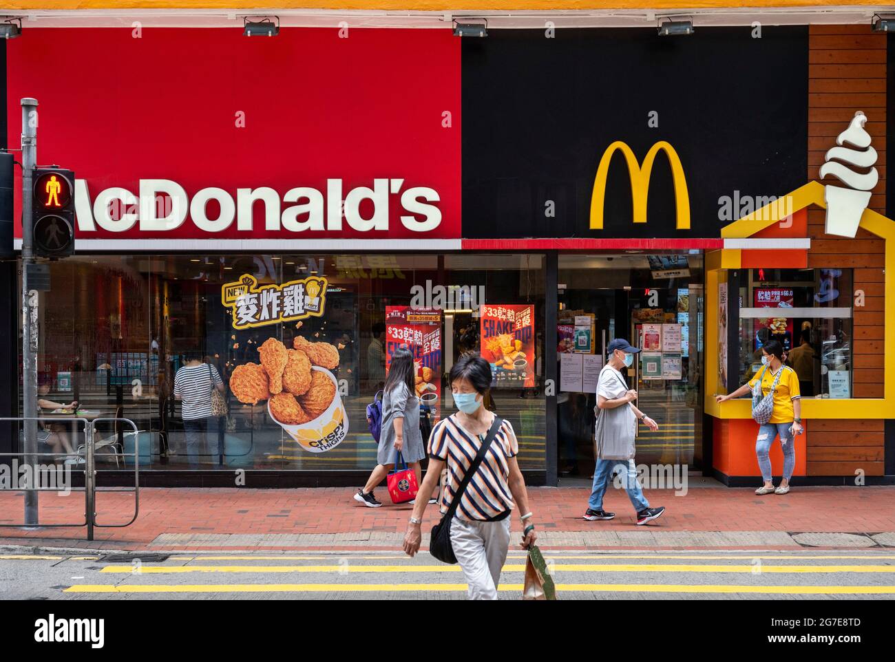 Pedestrians walk past the American multinational fast-food hamburger ...