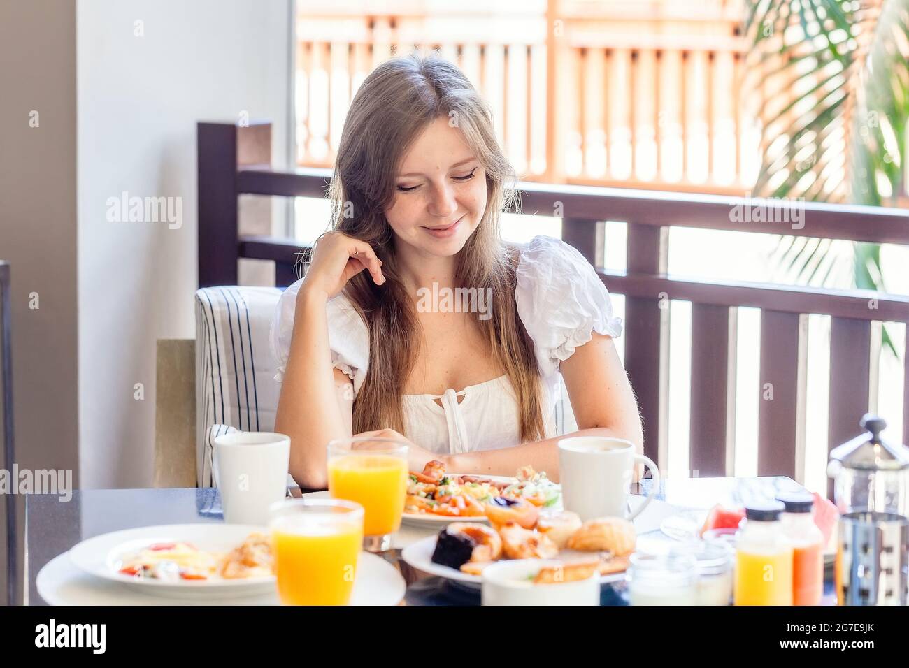 Young Smiling Woman Sitting on Breakfast with Plates Full of Food Stock ...