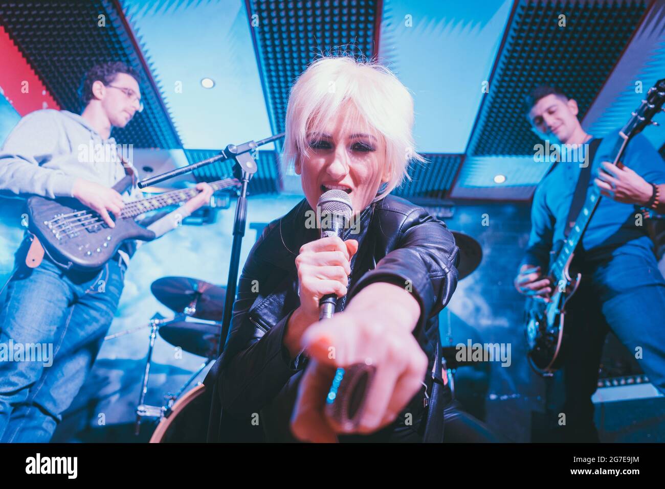 Band during gig making rock music on stage together Stock Photo - Alamy