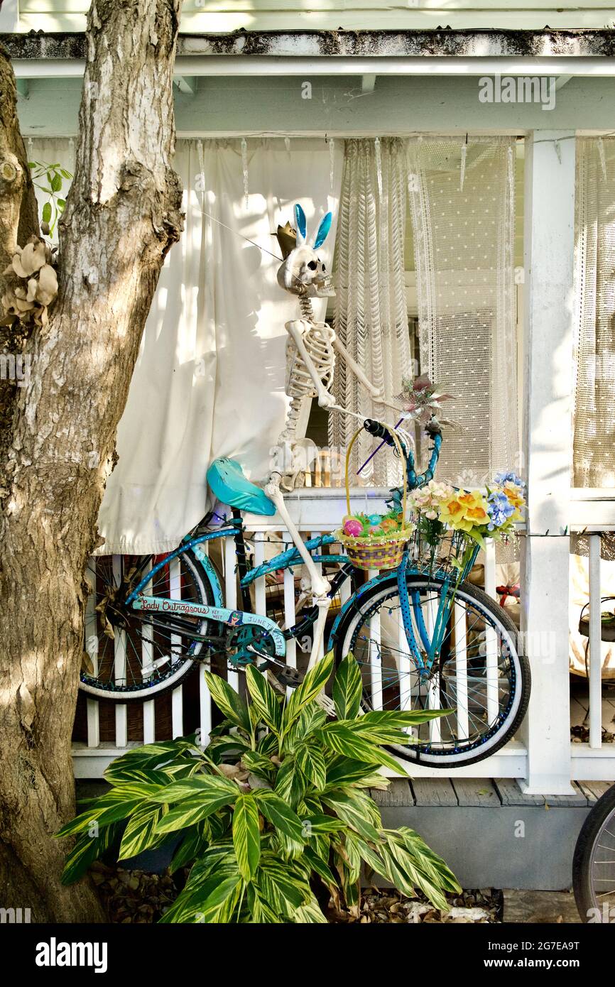 Human skeleton riding bicycle in humorous display outside house in Key ...