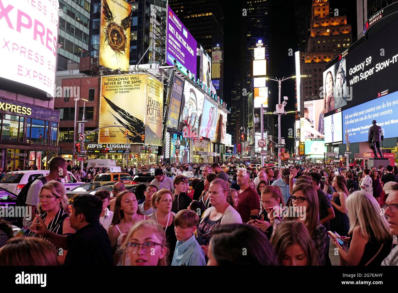 Tourists gathering at night in Times Square, Manhattan, New York City ...